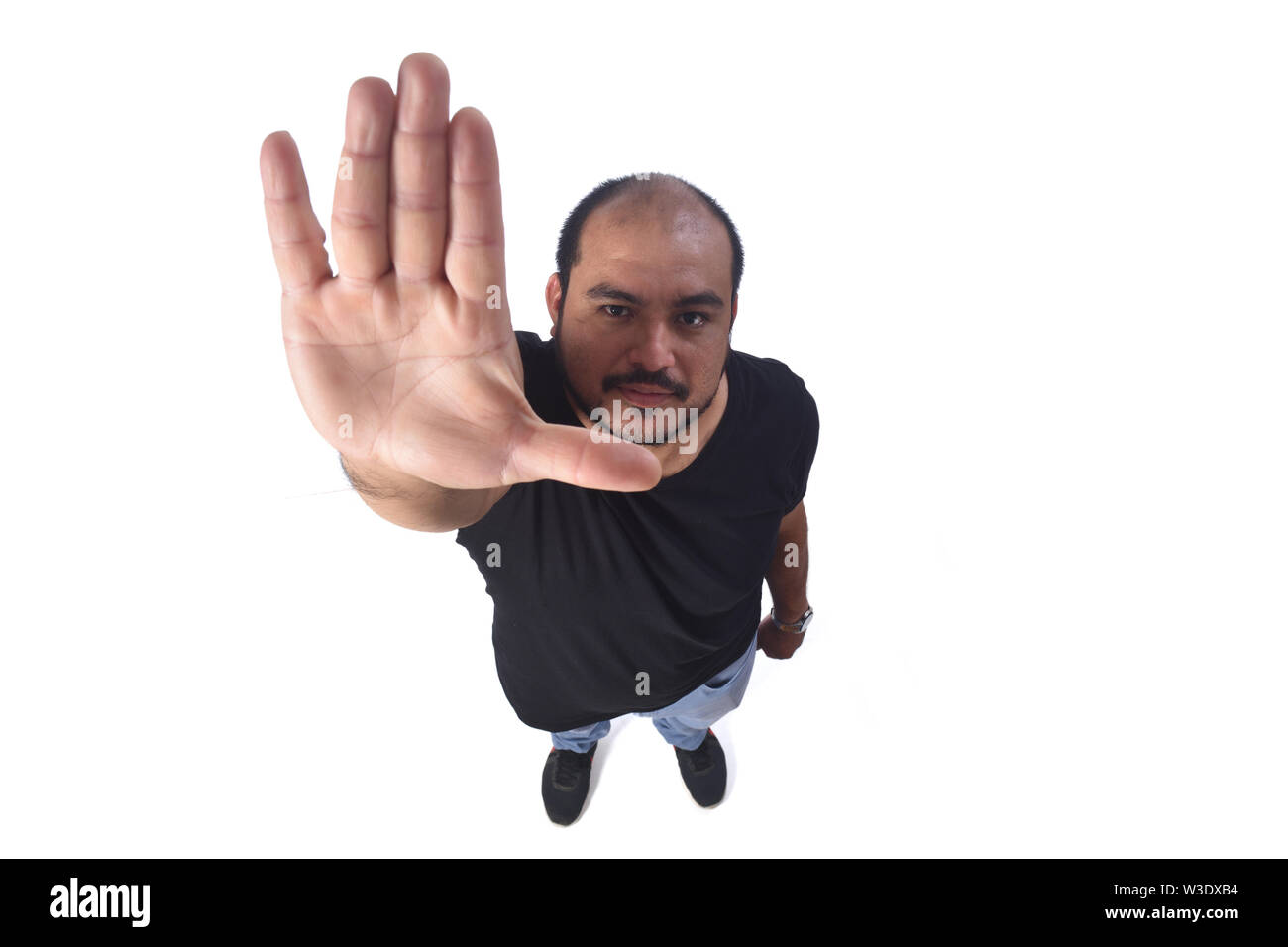latin man with stop sign on white Stock Photo - Alamy