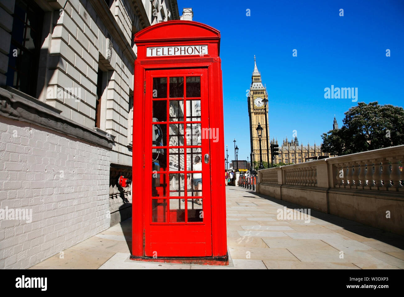Iconic Red Telephone Booth and Big Ben Clock Tower over blue sky ...