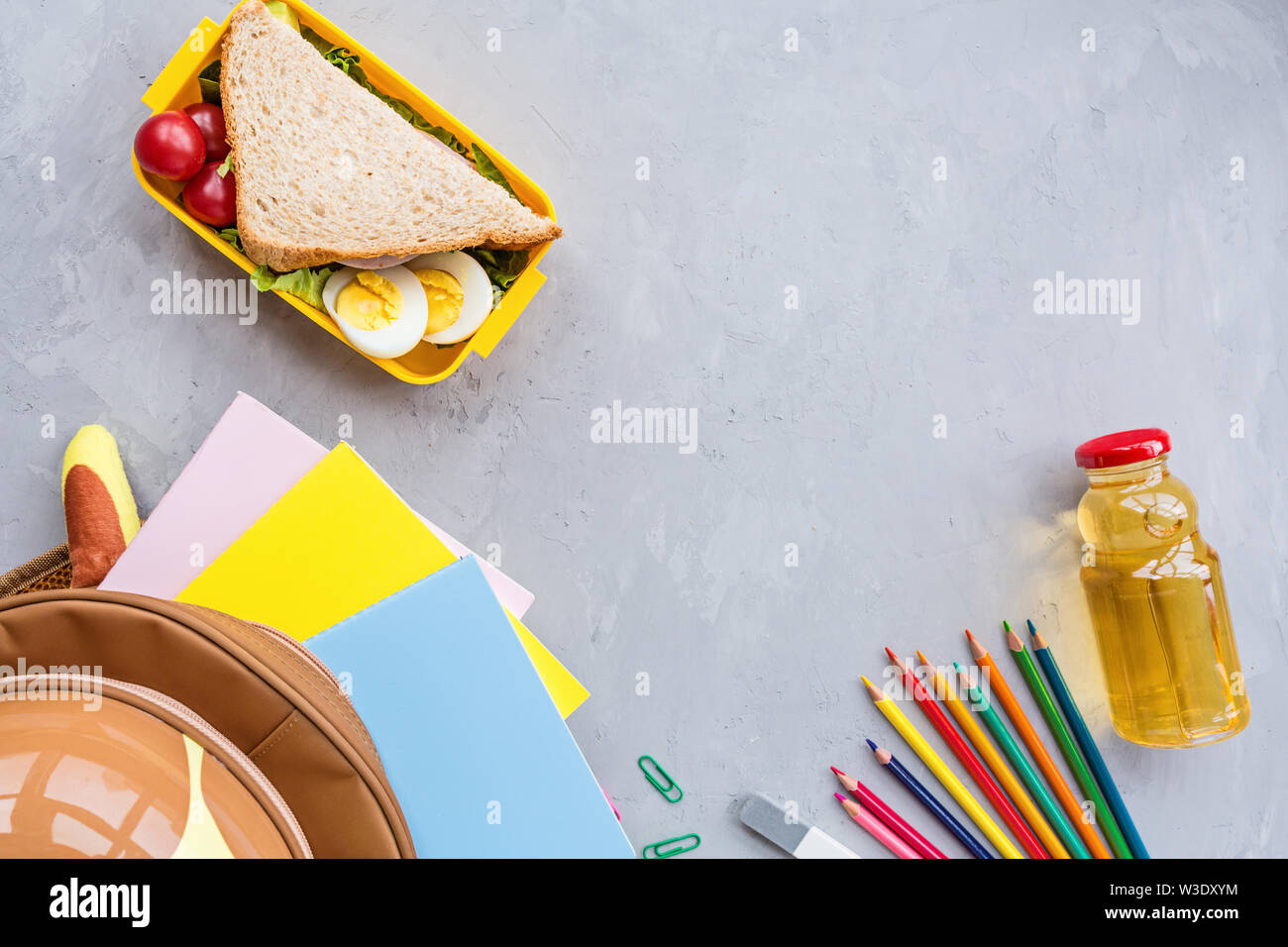 School supplies and lunch box with sandwich and vegetables. Back to ...