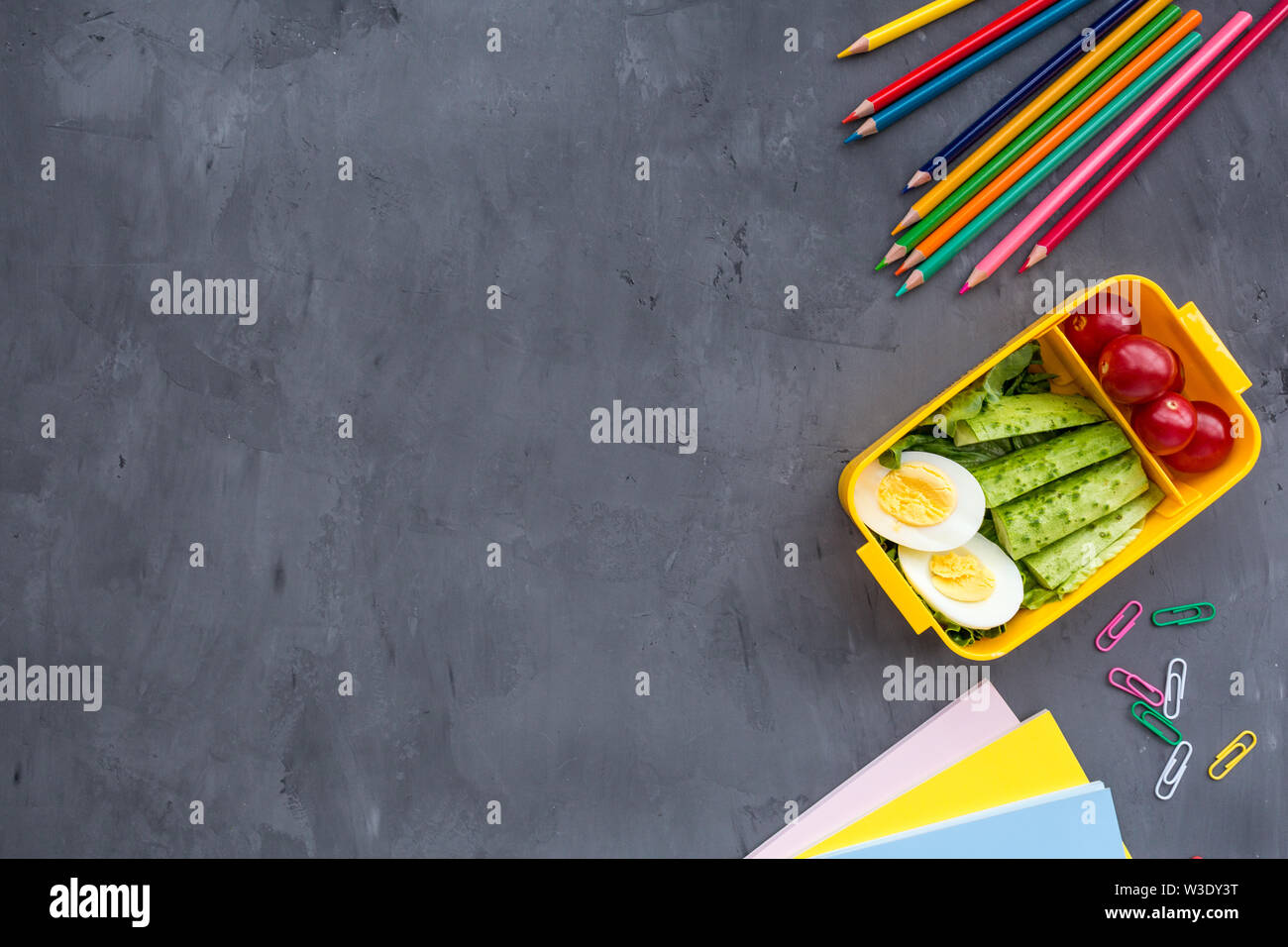 School supplies and lunch box with sandwich and vegetables. Back to ...