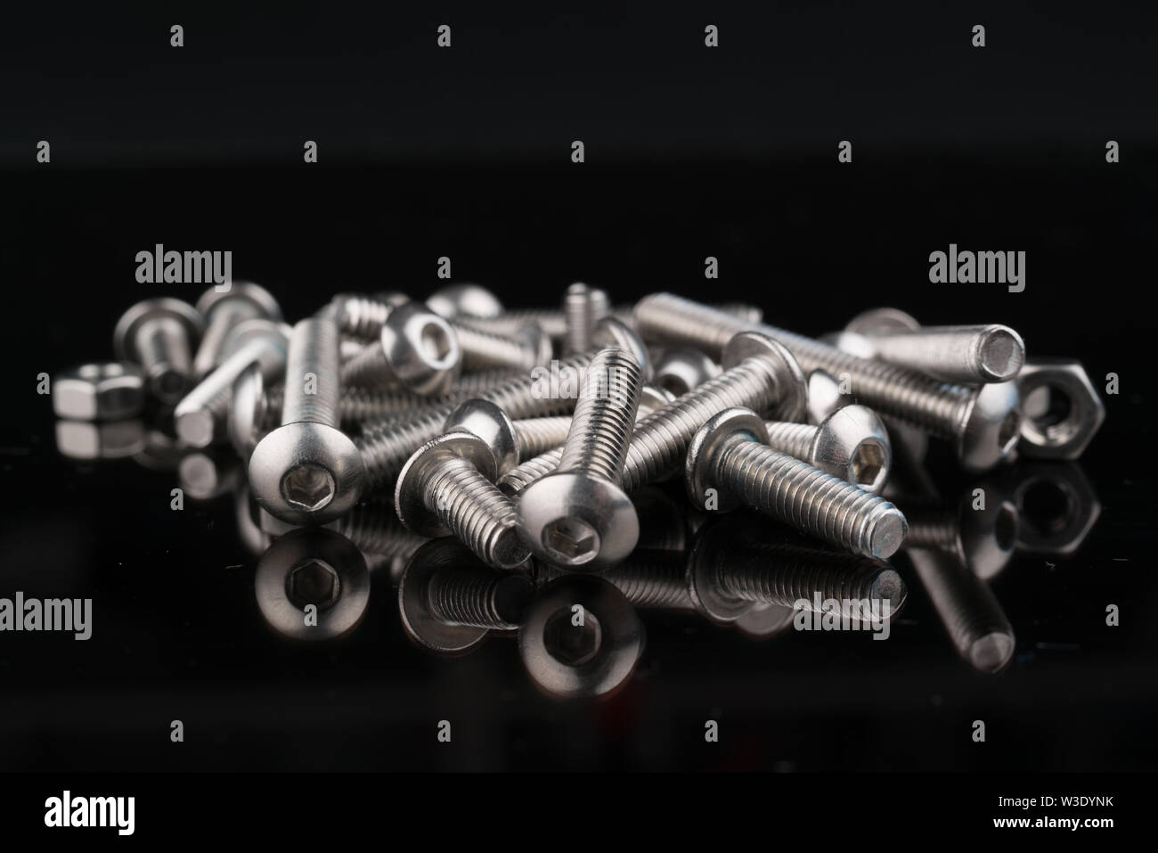 Screw and bolts on black background Stock Photo - Alamy