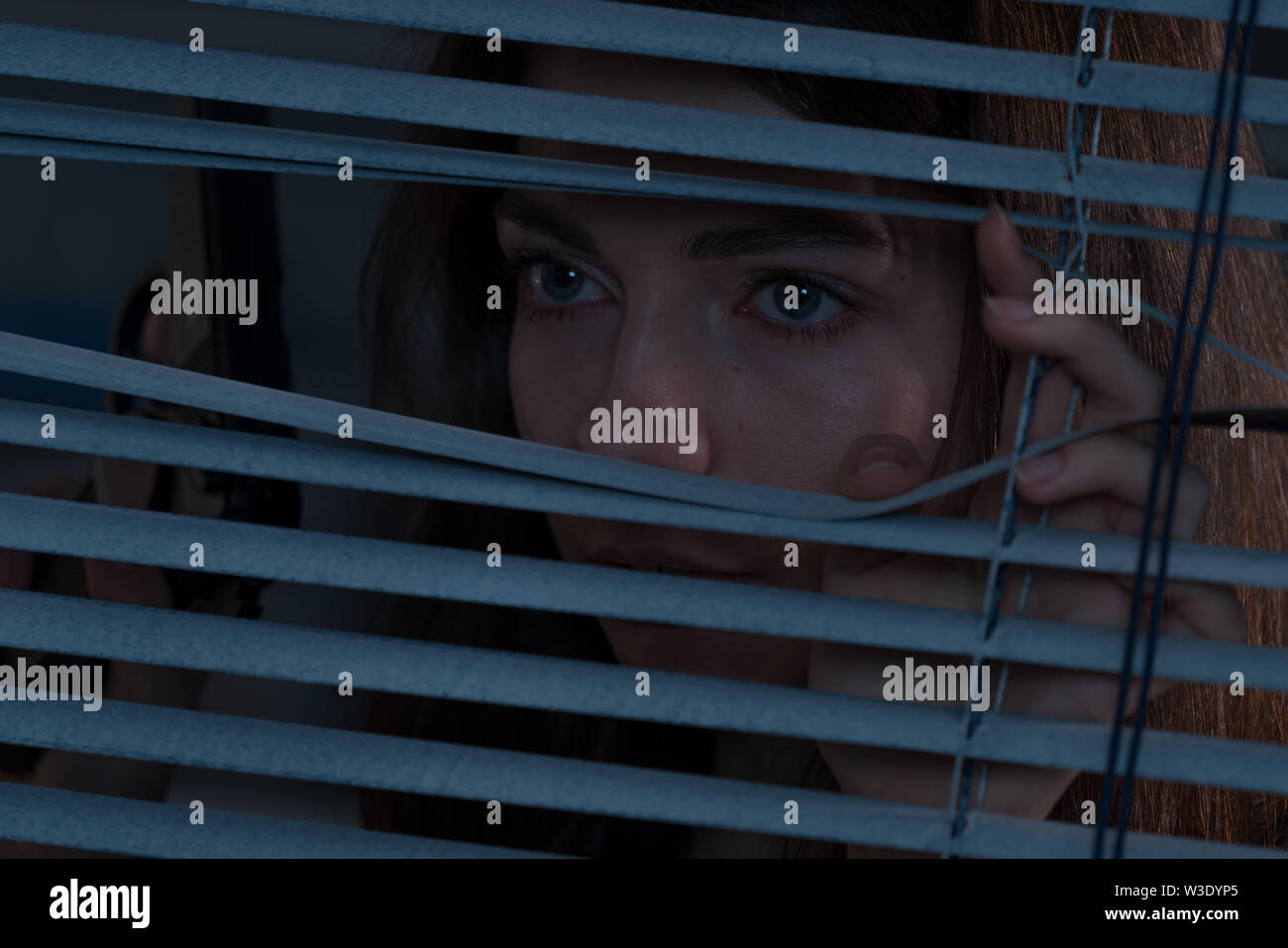 young woman with a gun at the window Stock Photo - Alamy