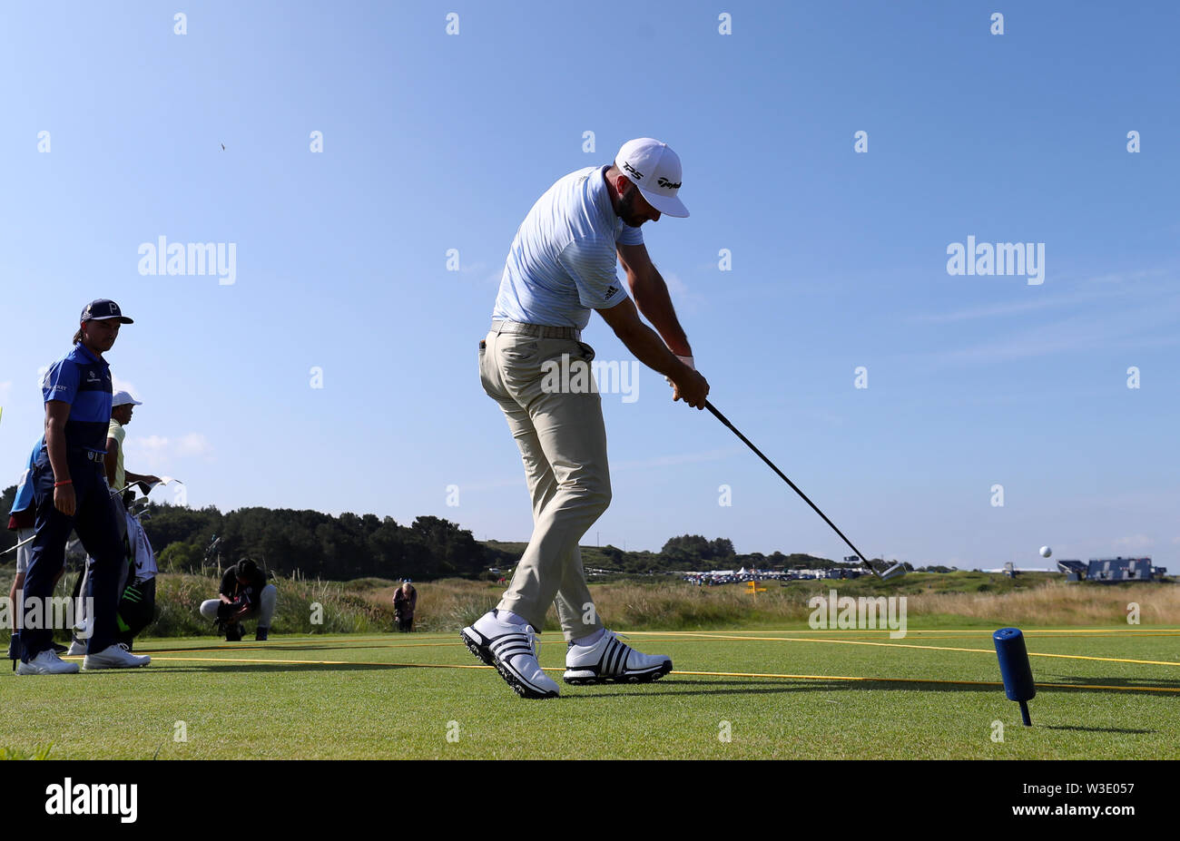 Rickie Fowler watches Dustin Johnson tee off from the 9th during ...