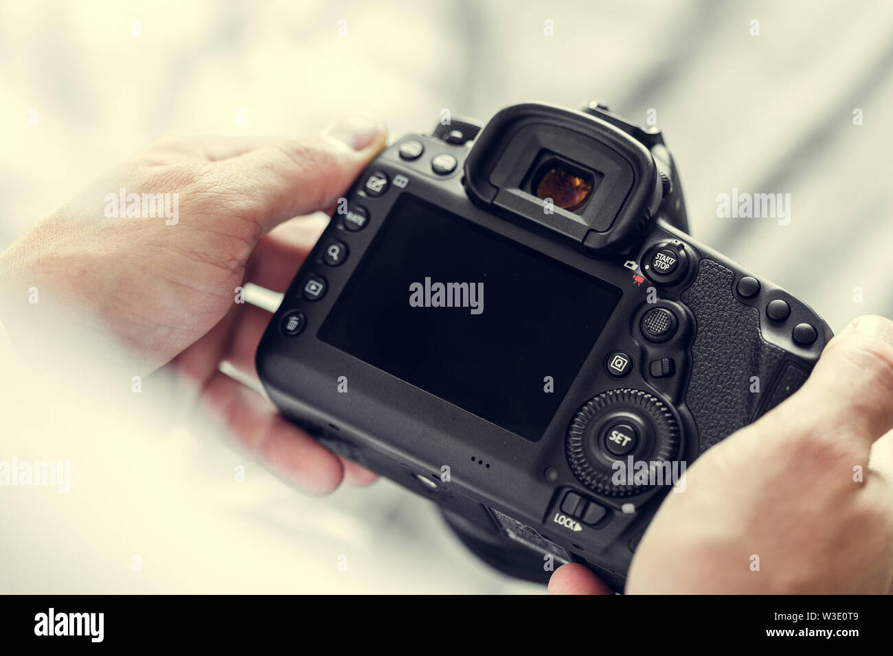 photographer with camera in hand Stock Photo - Alamy