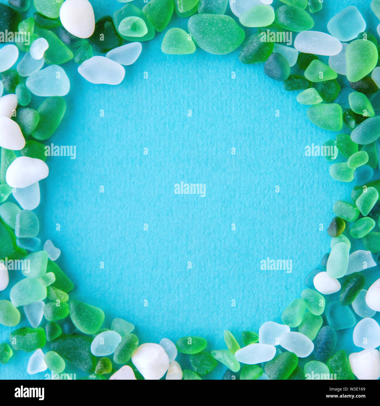 Close up of various sea glass pieces with empty circle shape in the ...