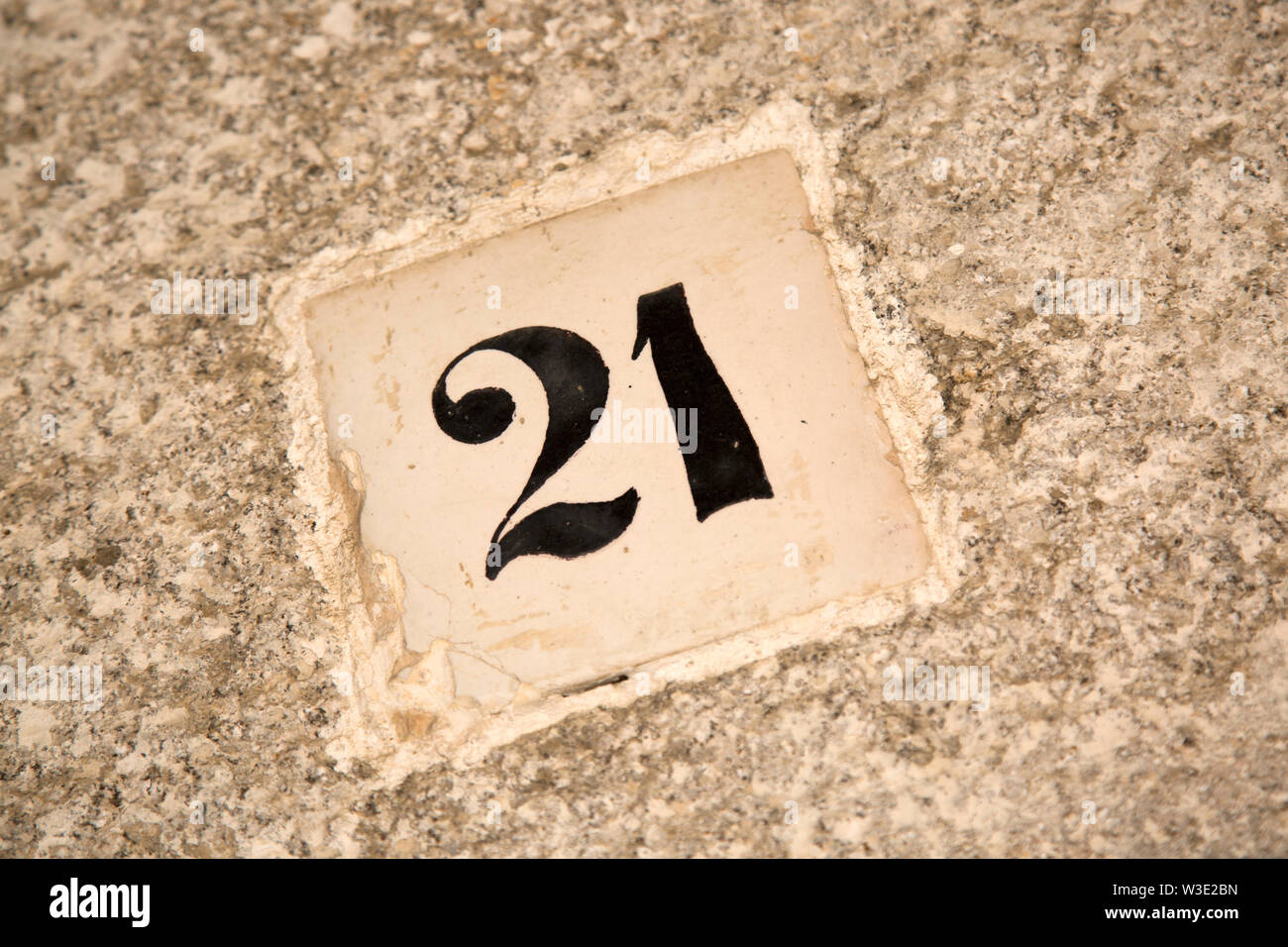 Number Twenty-one on Stone Wall Stock Photo - Alamy