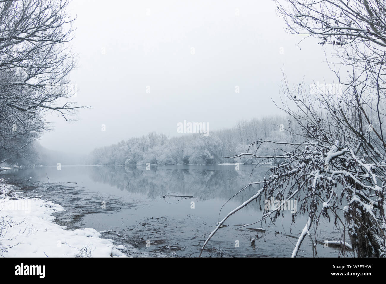 Winter lake scene reflecting in the water Stock Photo - Alamy