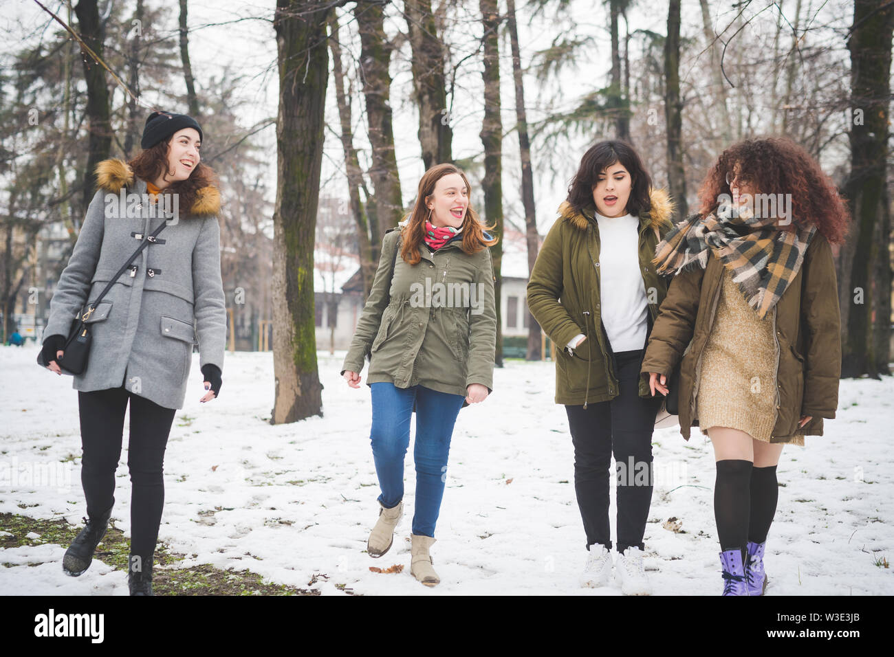 group of young women walking in park and having talk– togetherness ...