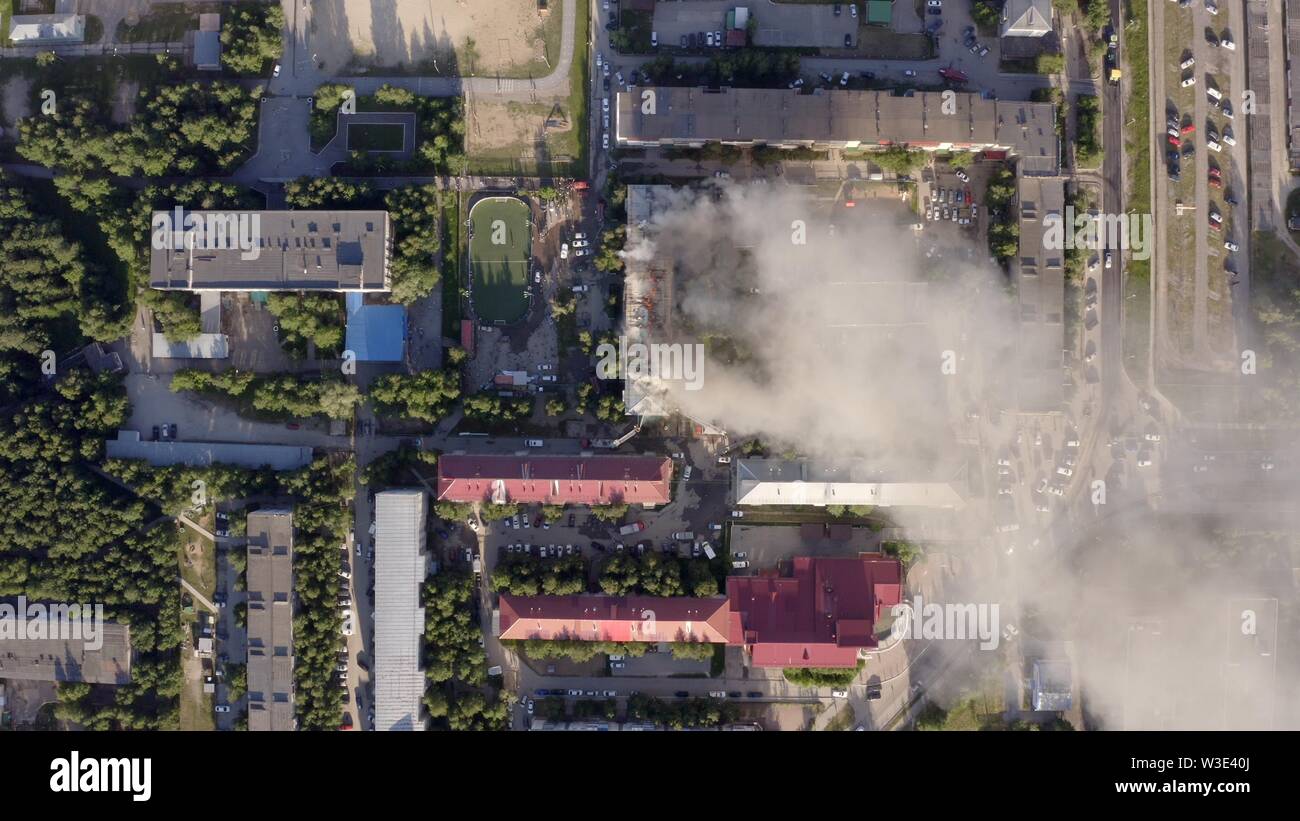 Burning roof of a residential high-rise building, clouds of smoke from ...