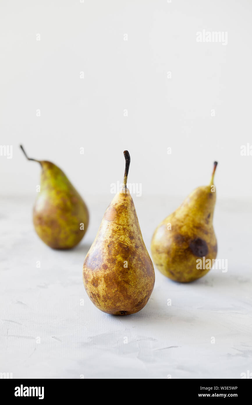 Trendy ugly organic fruits - three yellow pears on the table with copy ...