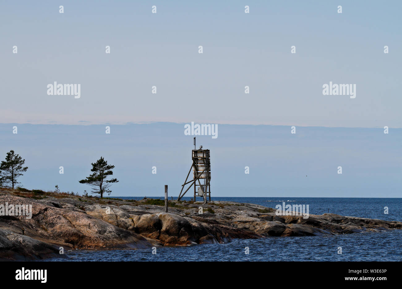 A sea mark standing on a cliff on the islet of the Bothnian sea Stock ...