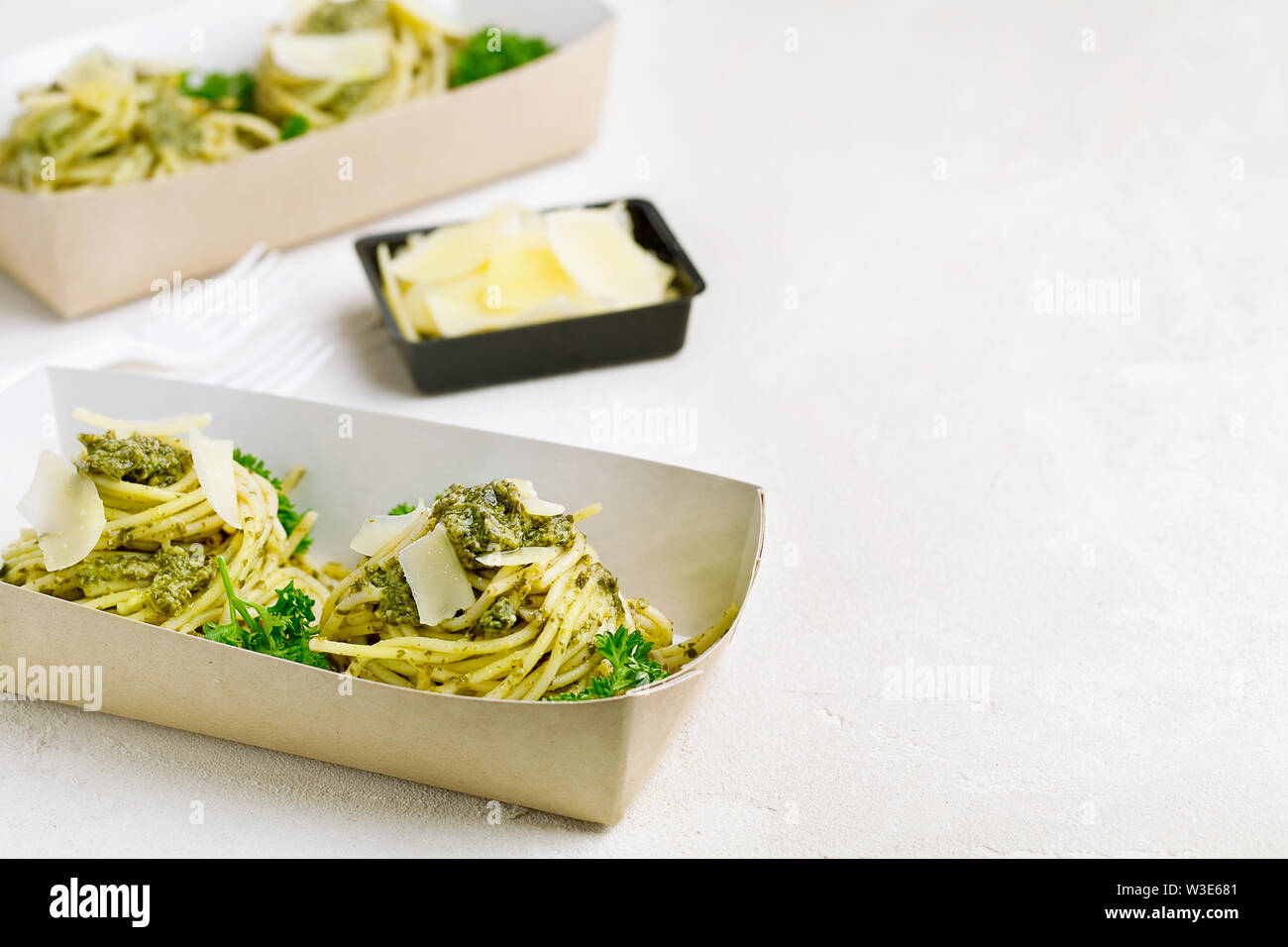 Pasta with pesto sauce decorated with parmesan in a traditional take ...