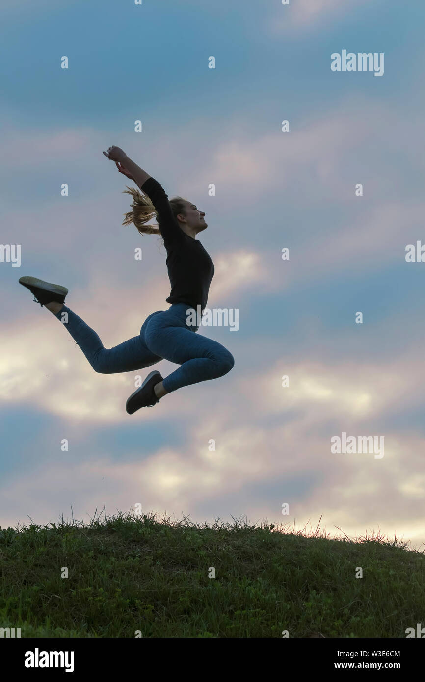 Cheerful Positive Girl Jumping in the Air Outdoor Morning Clouds ...