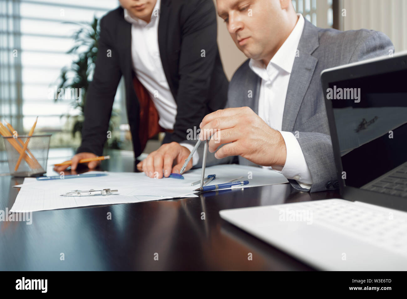 Confident team of engineers working together in a architect studio ...