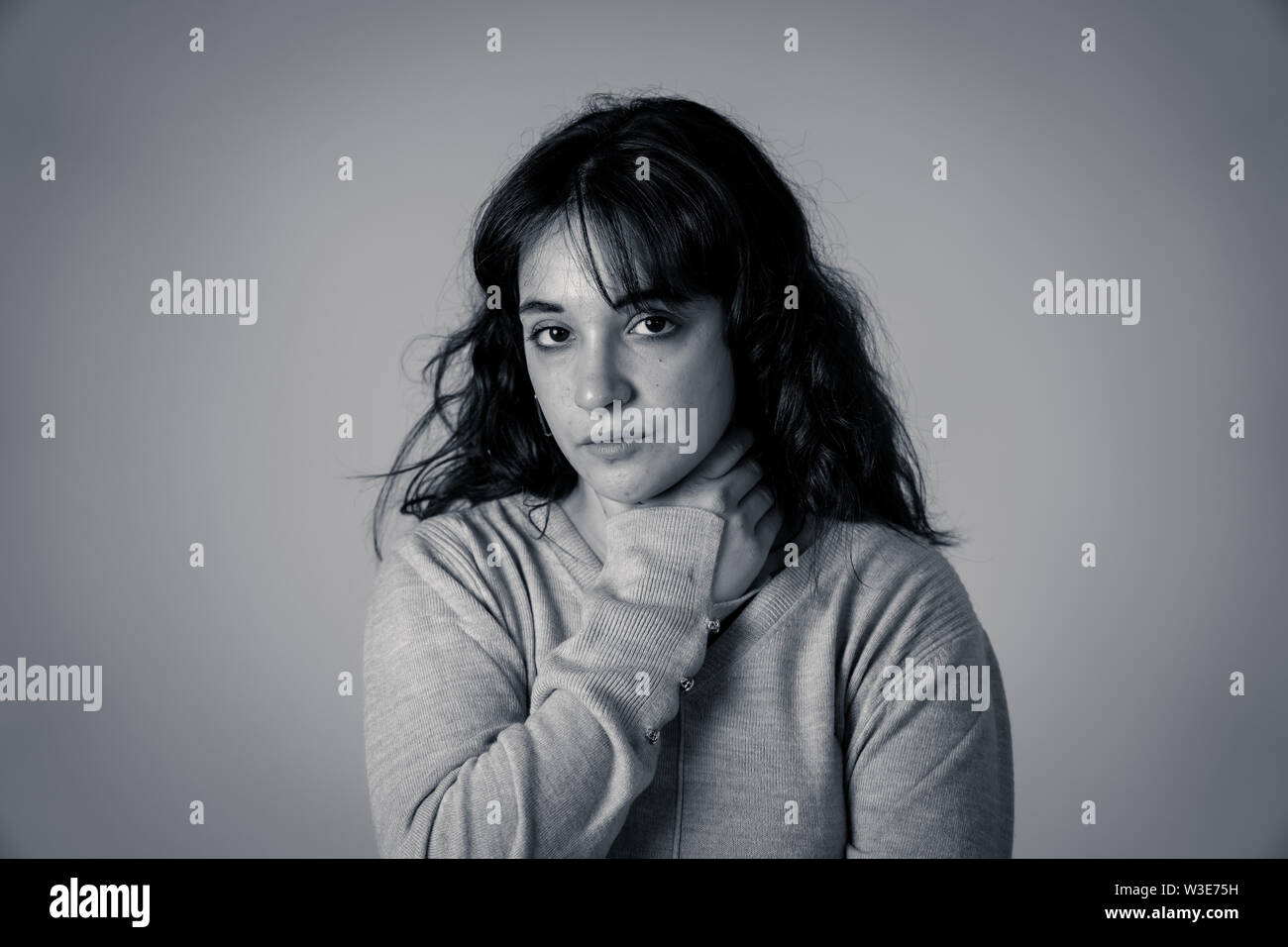 Close up portrait of beautiful young woman with sad eyes looking desperate and melancholy. Human ...