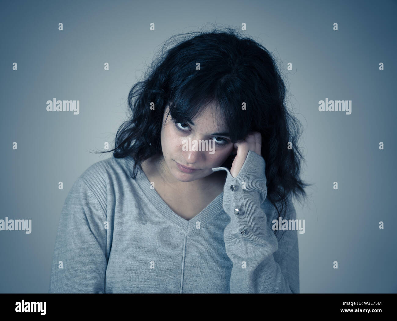 Close up portrait of beautiful young woman with sad eyes looking ...