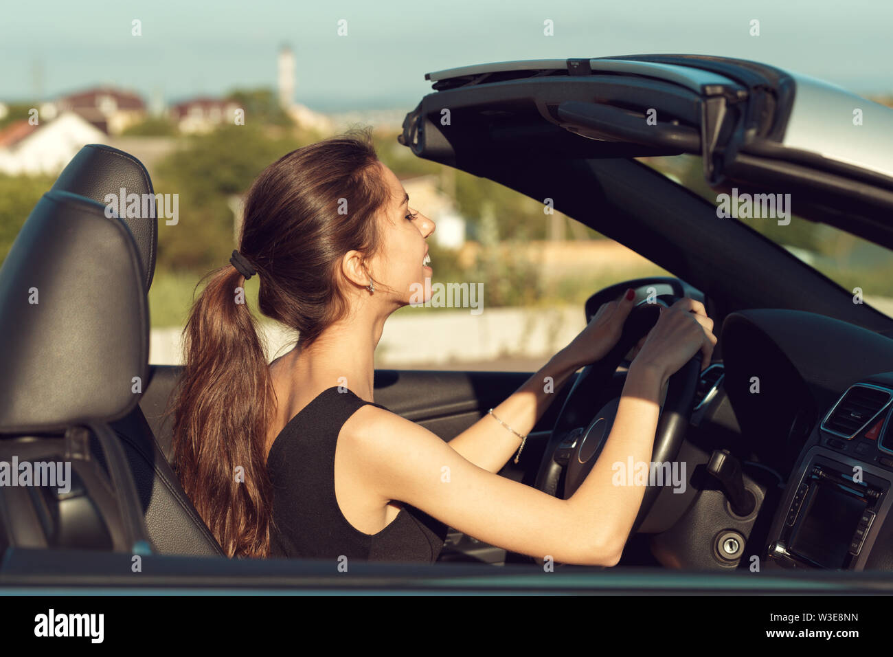 young girl driving cabrio car, on sunset light Stock Photo - Alamy
