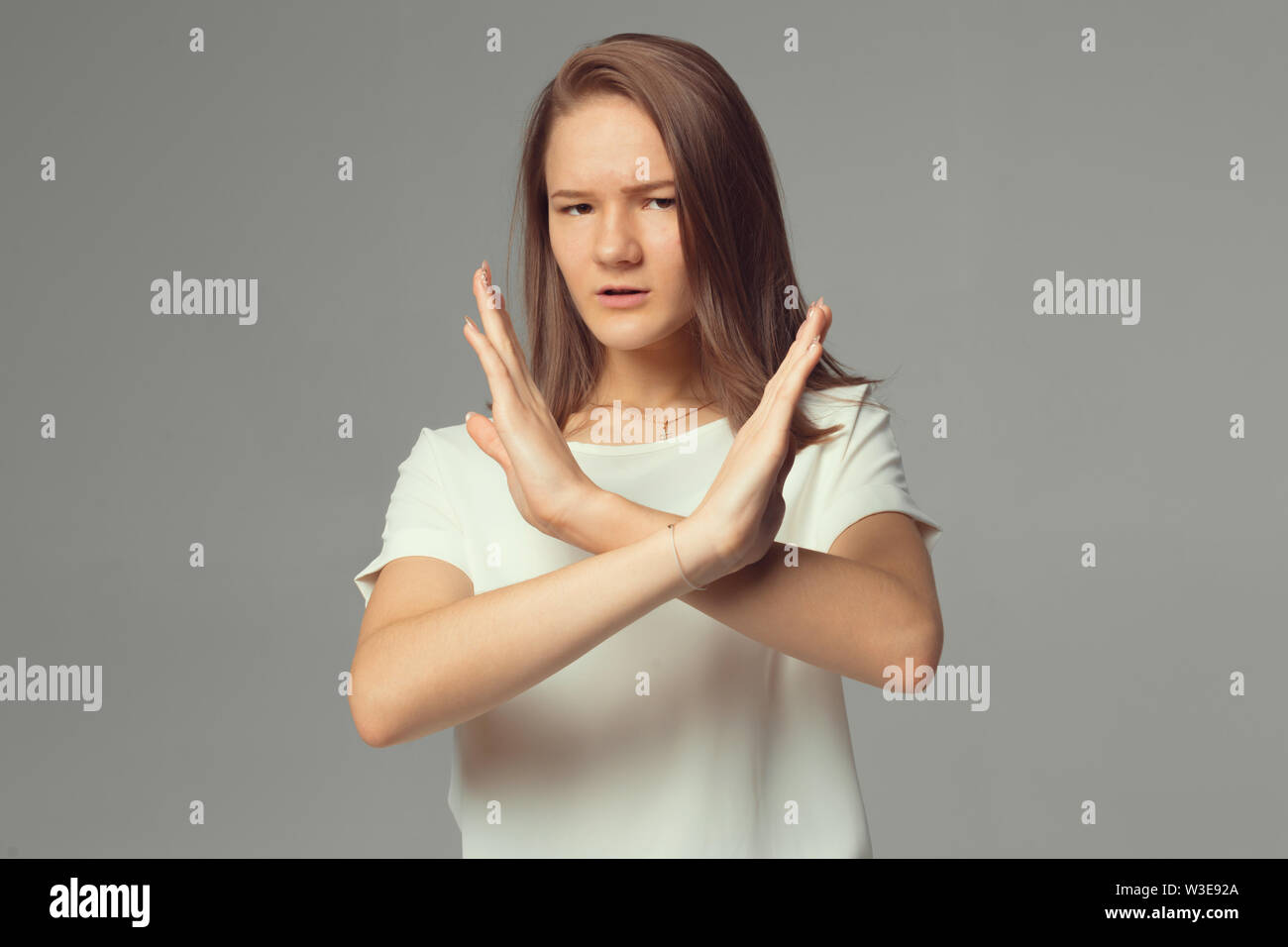 Portrait of young woman making stop sign Stock Photo - Alamy