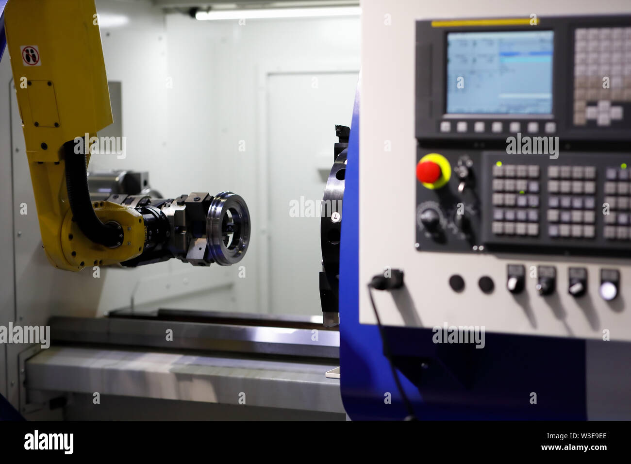 Process Of Automatic Loading Detail Into Cnc Lathe Machine With The Robot Arm Selective Focus