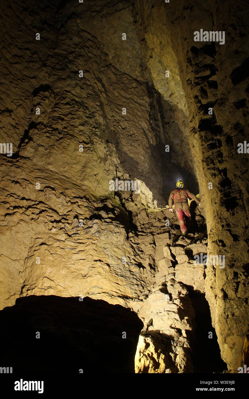 Caver exploring a cave Stock Photo - Alamy