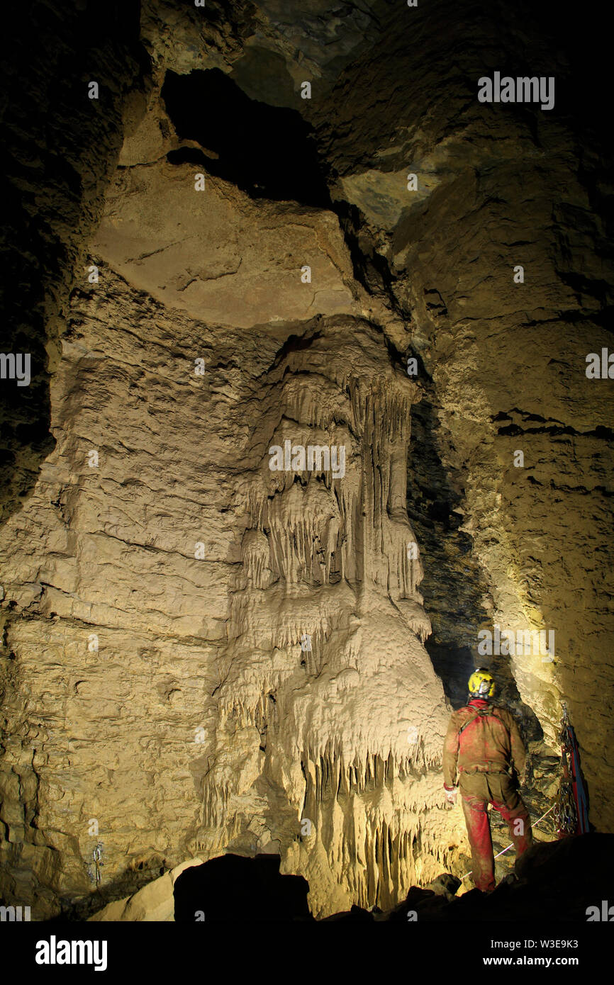 Caver exploring a cave Stock Photo - Alamy