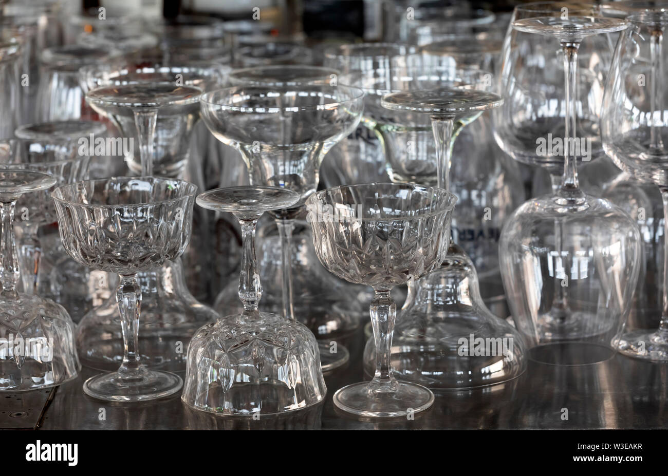 Glassware on a stainless steel hotel bar Stock Photo - Alamy