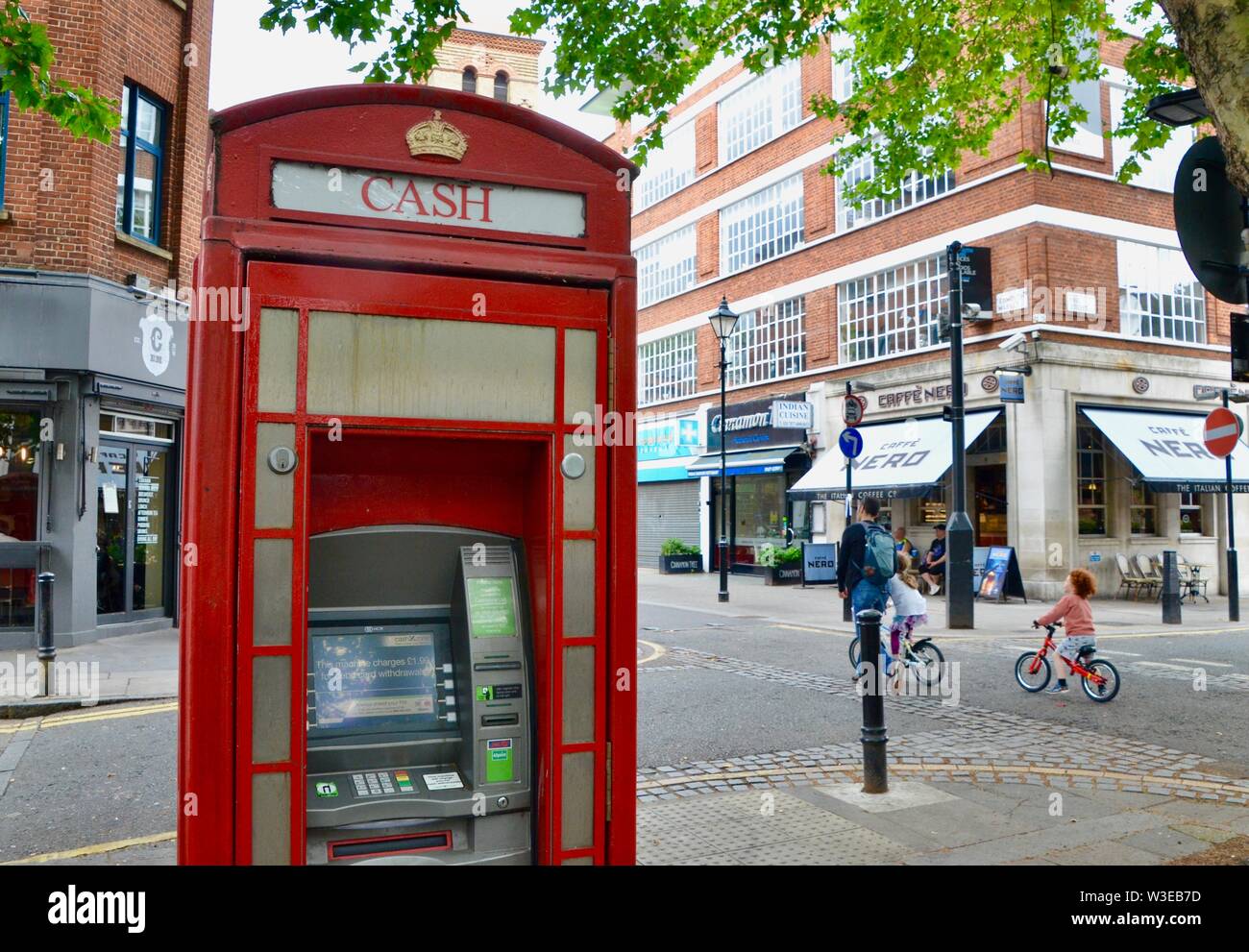 iconic red telephone box kiosk in london used as cash dispenser machine ...