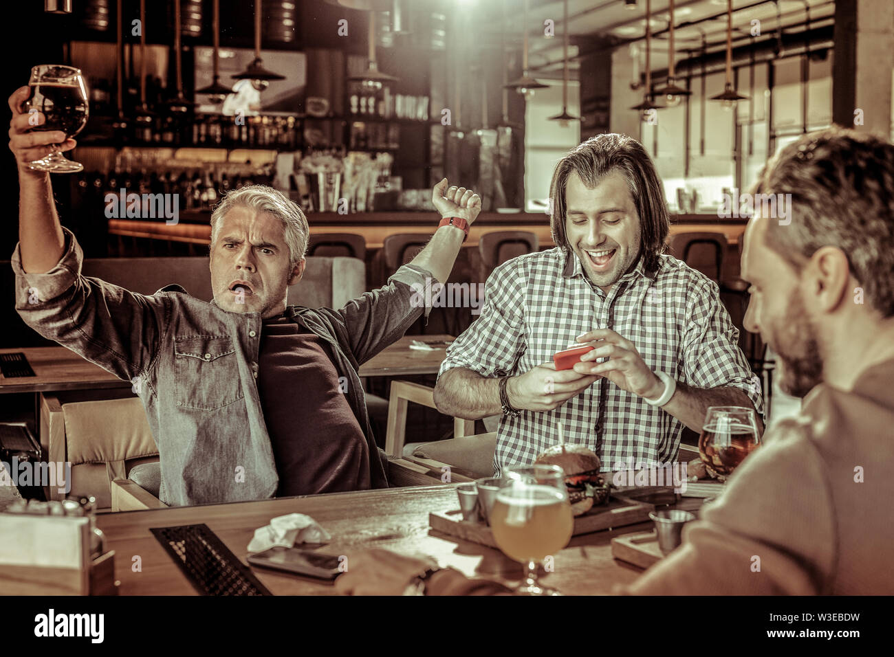 Positive delighted young man going to take picture Stock Photo - Alamy