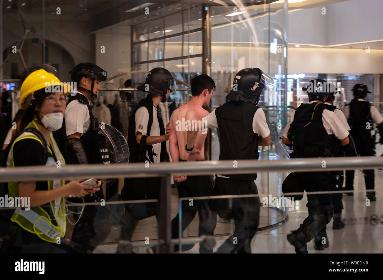 A protester handcuffed by the police during the demonstration.Thousands ...