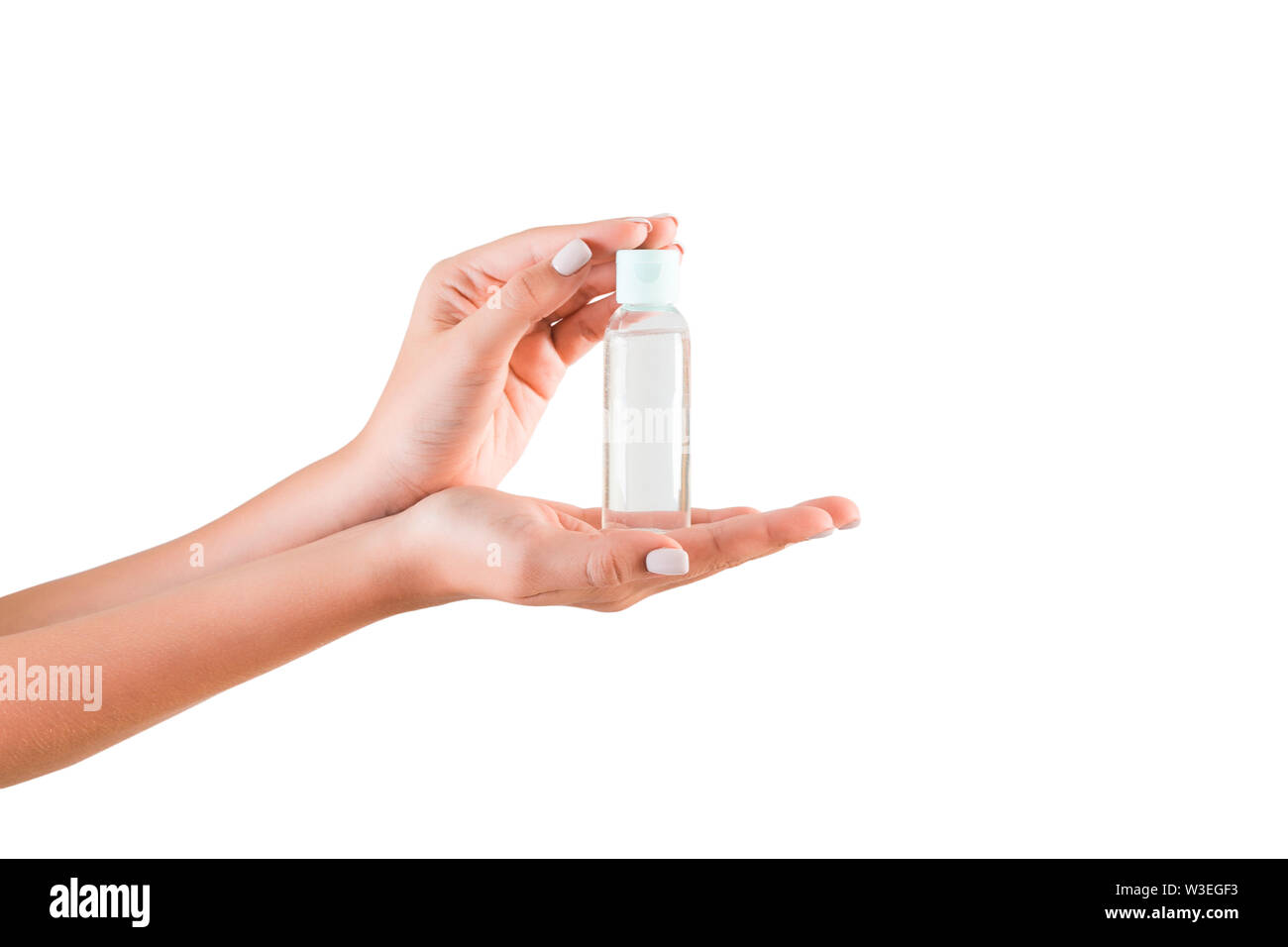 Female hand holding cream bottle of lotion isolated. Girl give tube ...