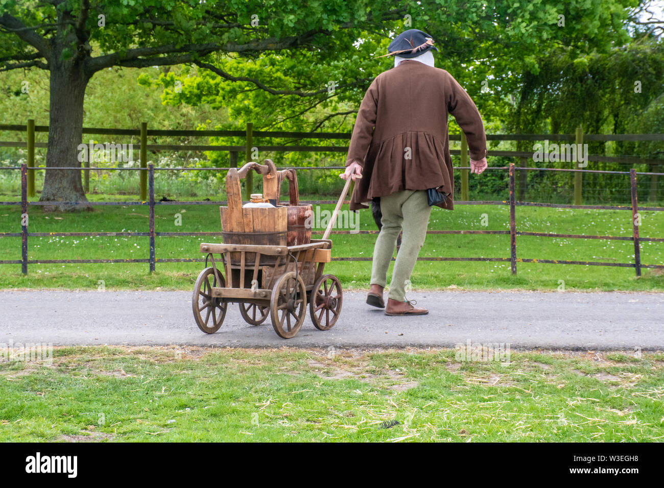 reenactor in medieval costume pulling medieval drinks cart Stock Photo ...