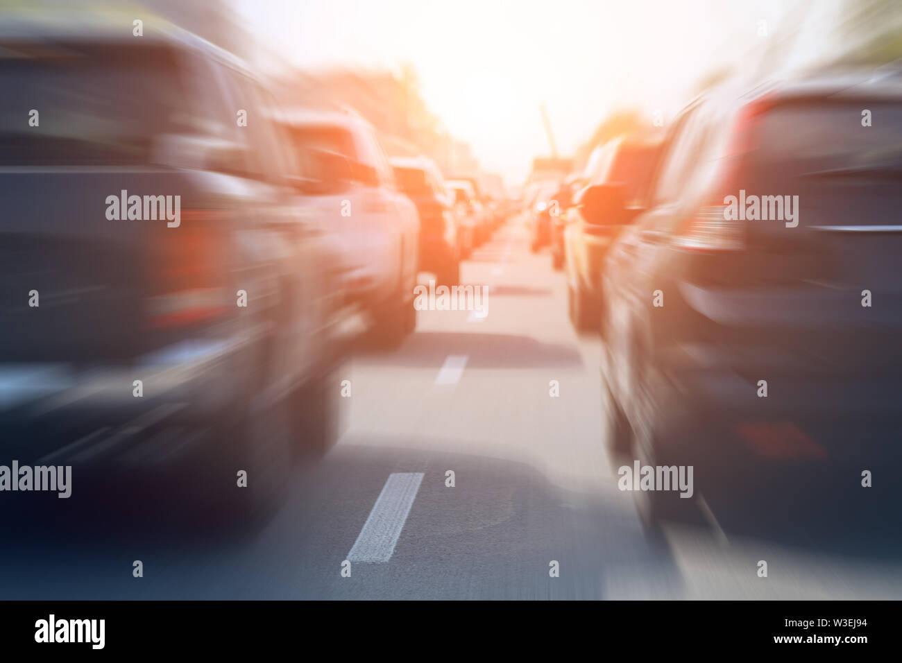 Evening traffic jam on busy city highway. Rows of car stck on road due ...