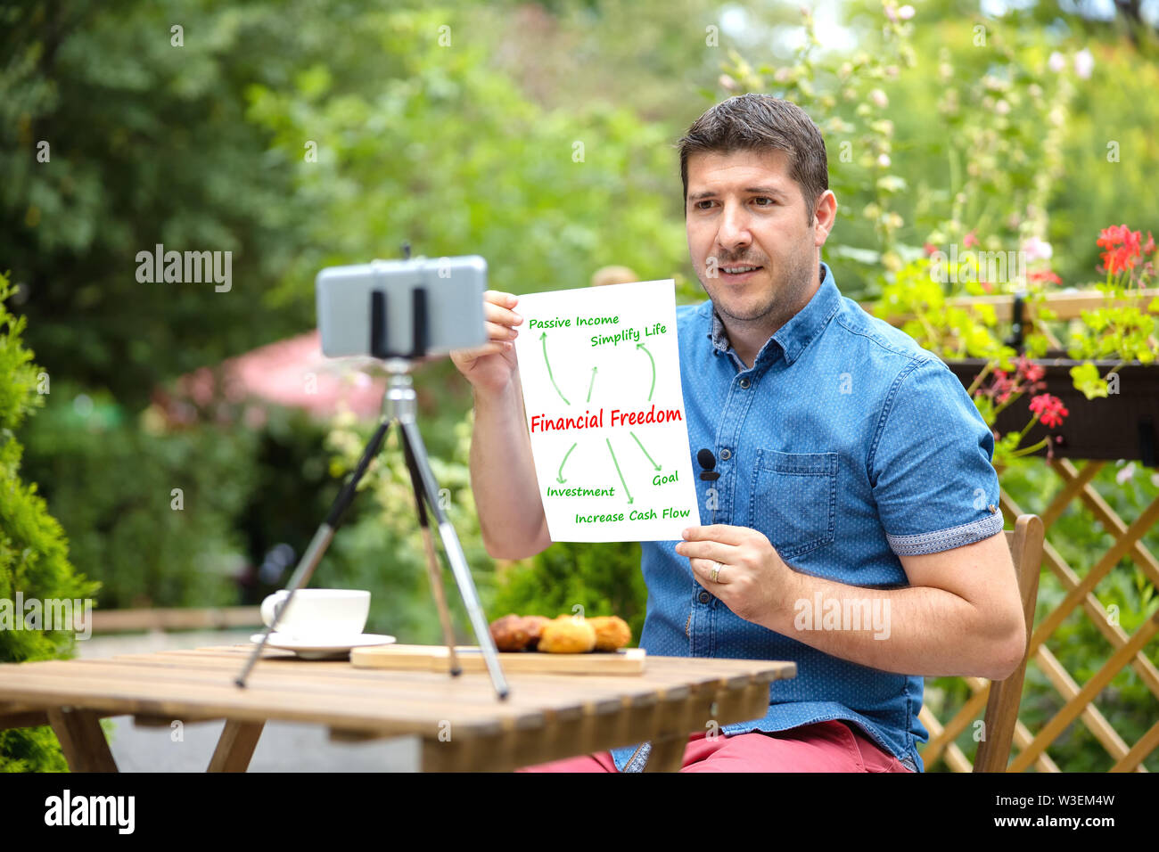 Content creator vlogging about financial freedom Stock Photo - Alamy