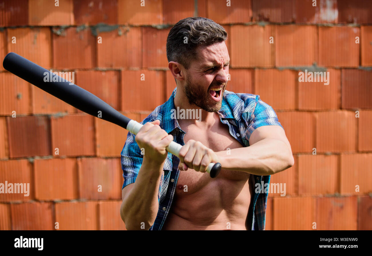 full of energy. unshaven muscular man fighting. man with baseball bat ...