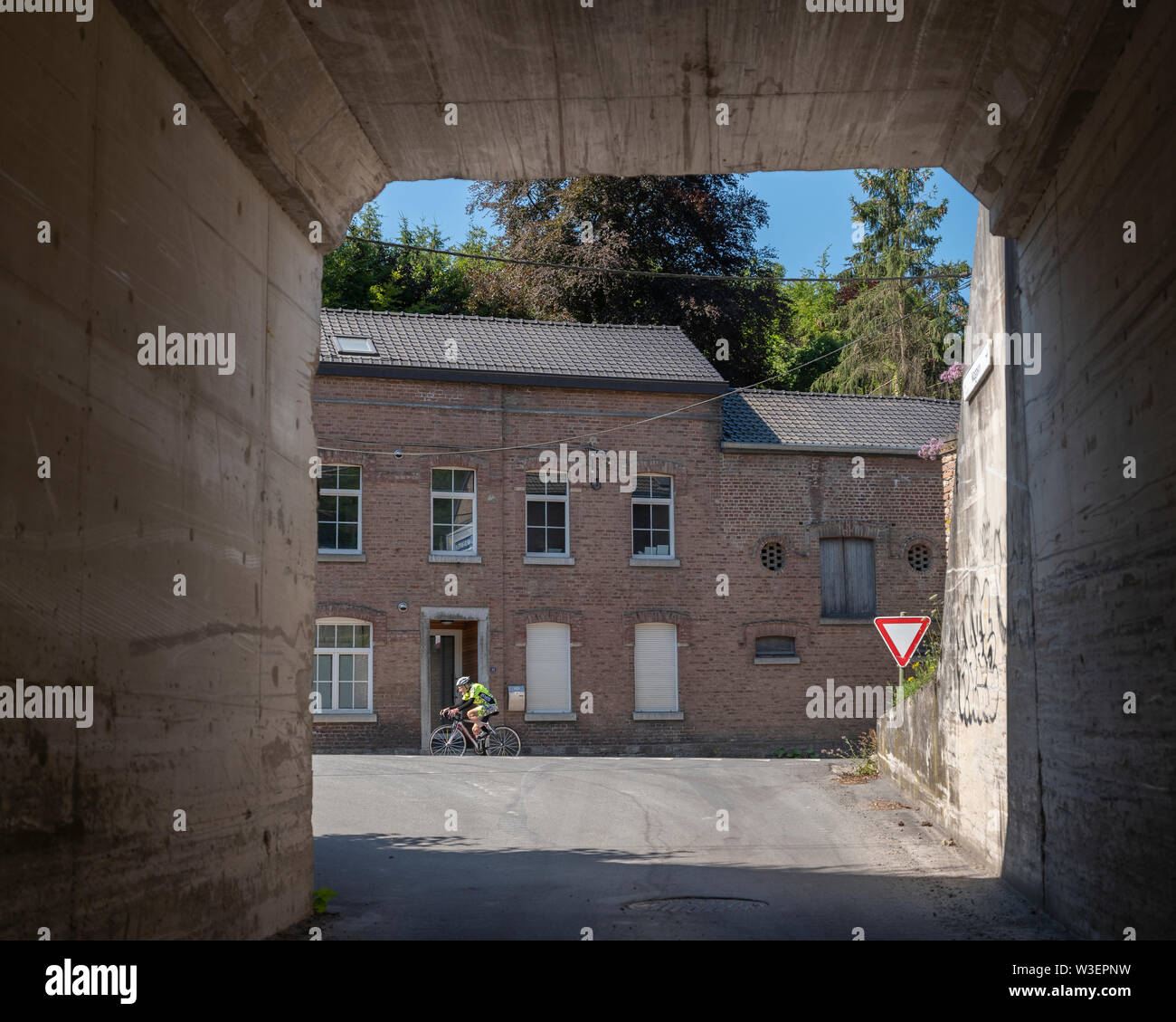 Trooz, Belgium, 4 july 2019: older man on bycicle passes old houses in ...
