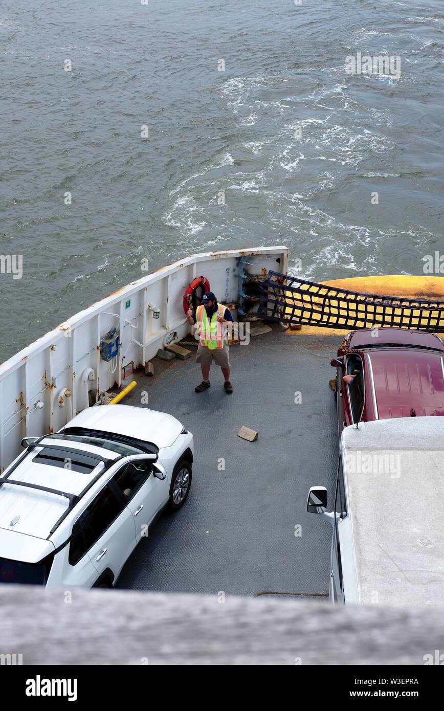 Cape May-Lewes Ferry employee inspects vehicles on deck Stock Photo - Alamy