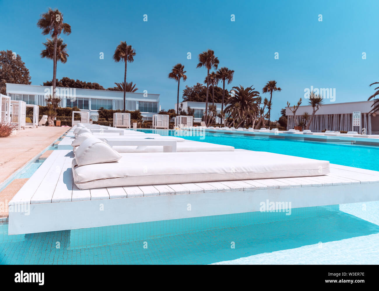 Luxury beach resort, gorgeous white sunbeds near the pool with ...