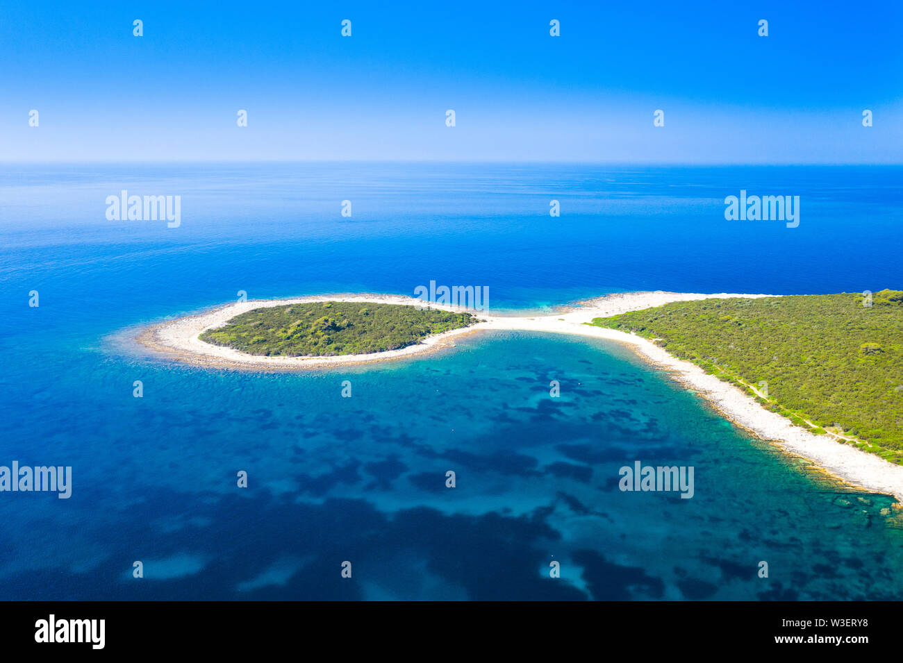 Rocky fish shaped cape in turquoise sea, clear blue water on the island ...