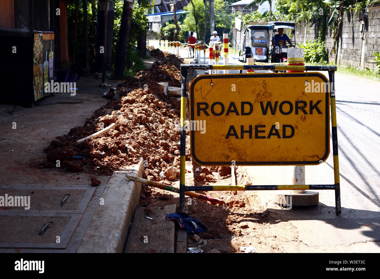 ANTIPOLO CITY, PHILIPPINES – JULY 11, 2019: A “Road Work Ahead” sign at ...