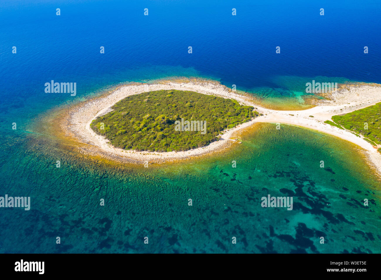 Rocky fish shaped cape in turquoise sea, clear blue water on the island ...