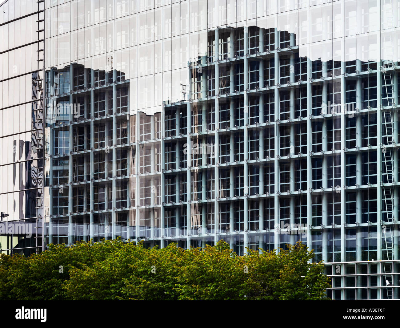 The modern building from glass and steel. Reflections in a glass facade ...