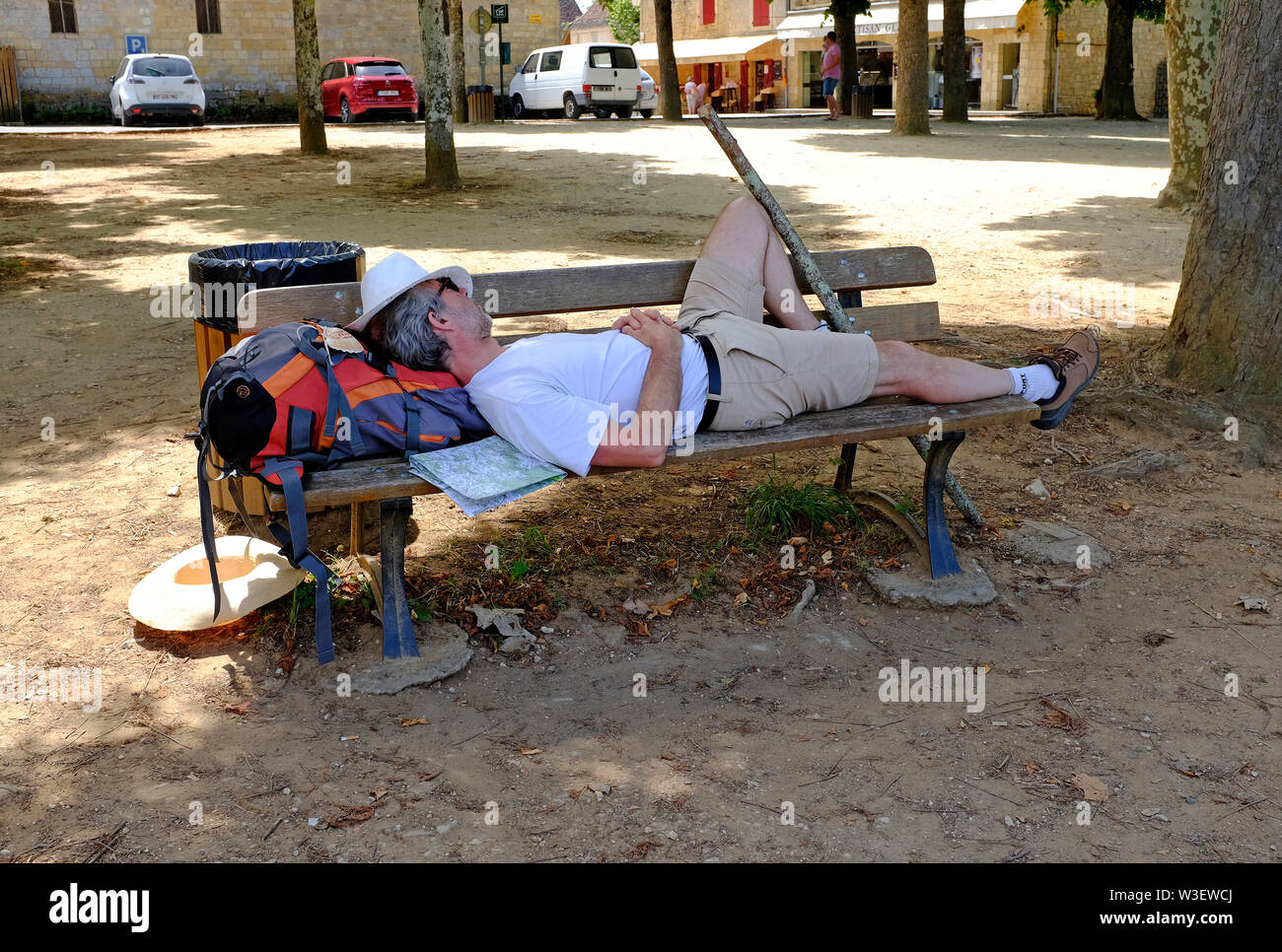 male traveller sleeping on bench, domme, dordogne, france Stock Photo ...