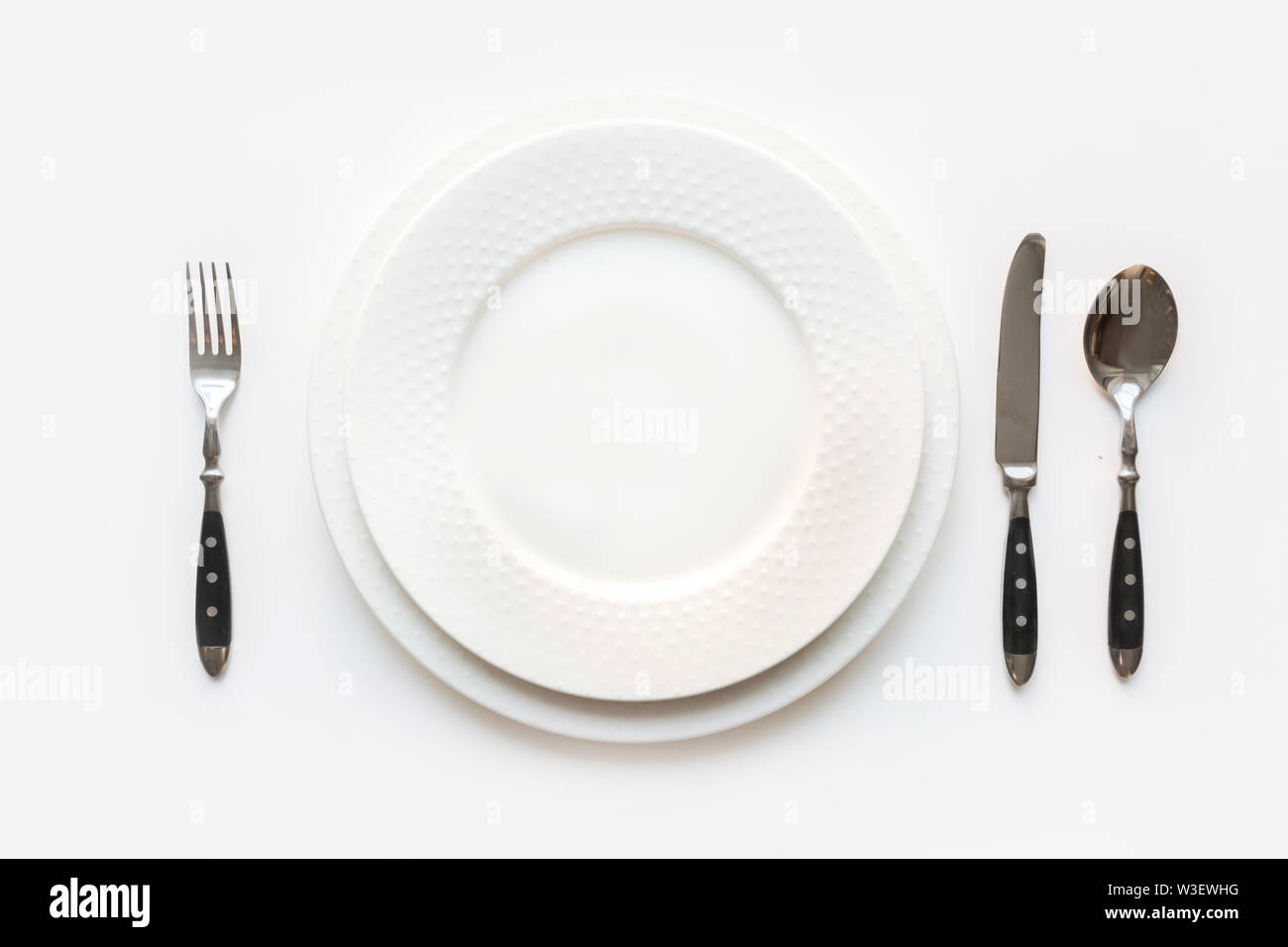 Elegance empty table setting with silverware on holiday white table ...