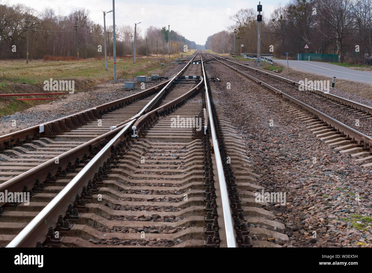 railway stretching into the distance, rails in three rows Stock Photo ...