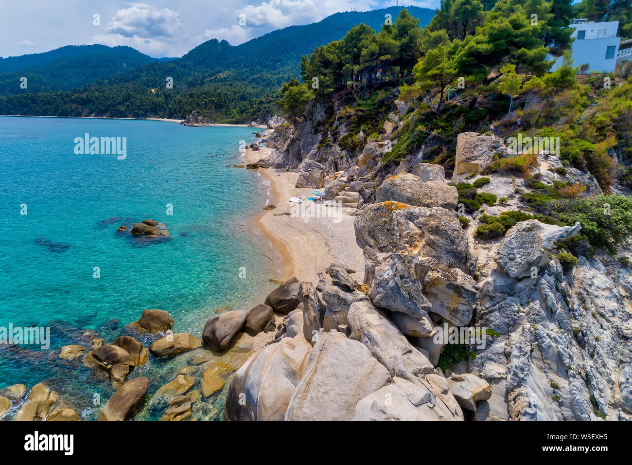 Aerial View of the beach Fava with colorful umbrellas, swimming people ...