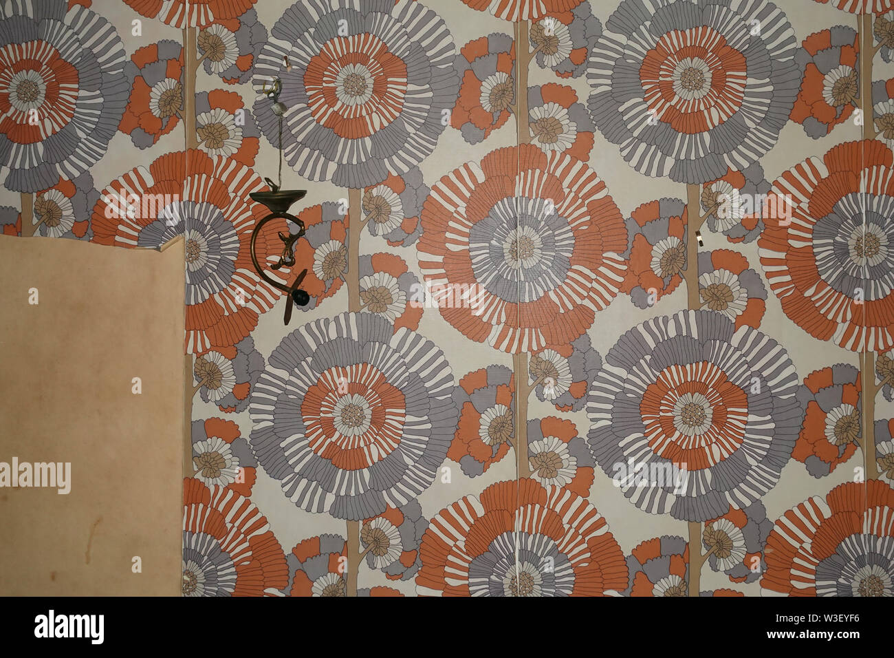 Broken lamp on bedroom wall of an abandoned house and torn vintage ...