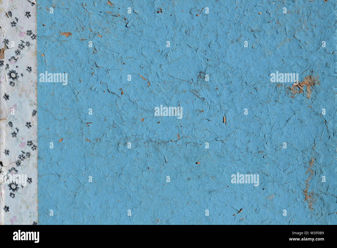 Old wooden flakeboard with blue paint and worn vintage floral pattern ...