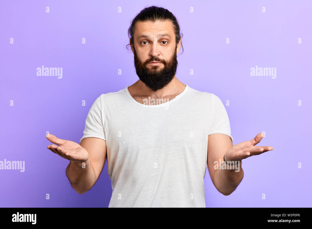serious man standing with raised hands, explaing something, talking ...