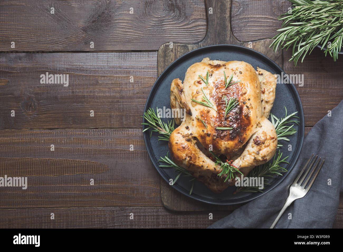 Traditional roasted turkey garnish rosemary on dark wooden table. Top ...
