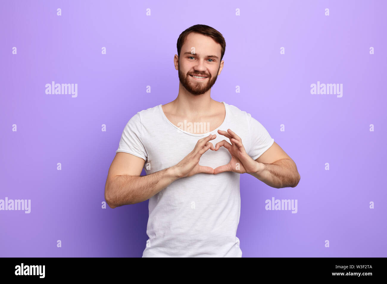 cheerful handsome guy showing heart symbol and shape with hands ...